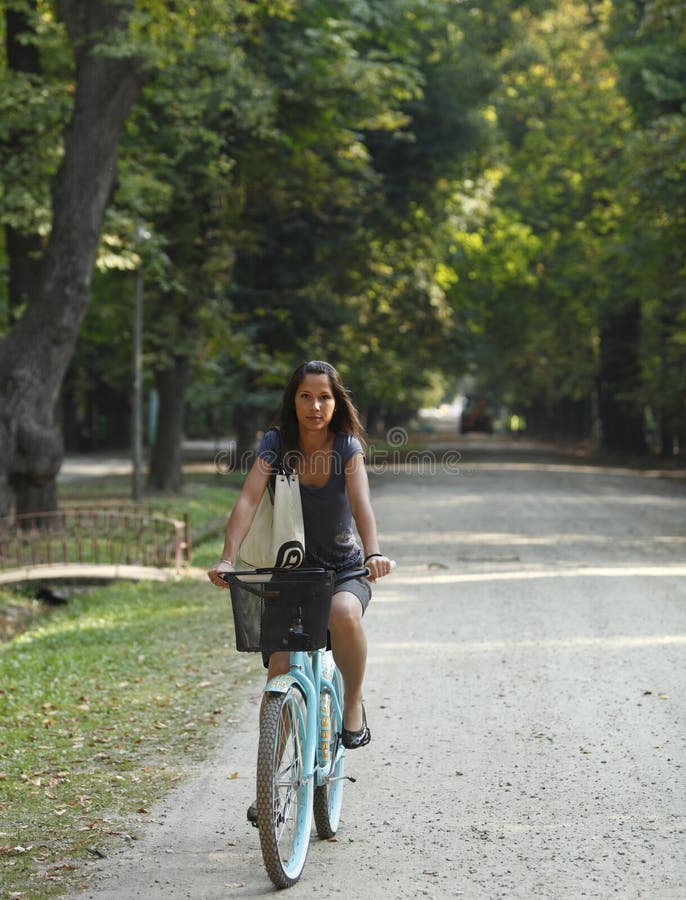 Woman Riding a Bicycle stock image. Image of adult, active - 12387243