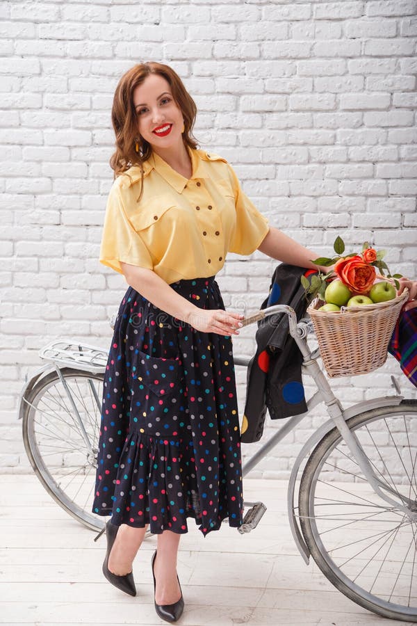 A Woman is Riding a Bicycle with a Crop of Apples in a Basket. Stock ...