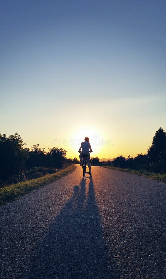 Woman Riding Bicycle on the Sunset Editorial Stock Photo - Image of ...