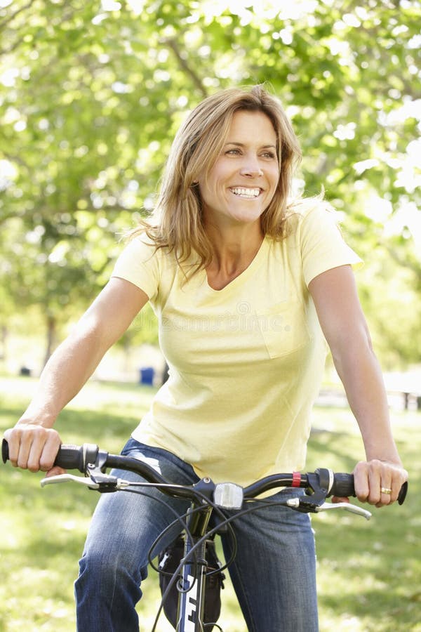 Woman riding bike stock image. Image of outdoors, riding - 54960413