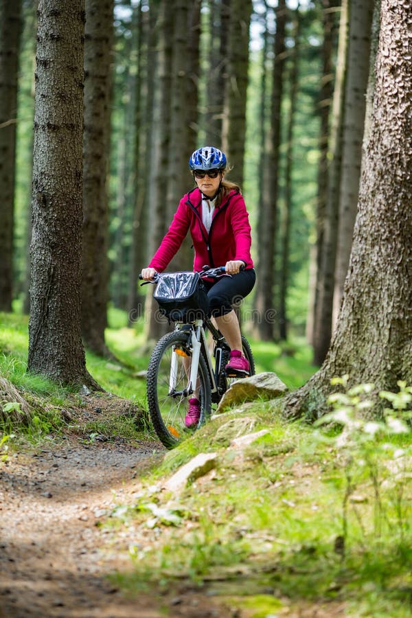 Woman riding bike stock image. Image of active, middleaged - 101335259