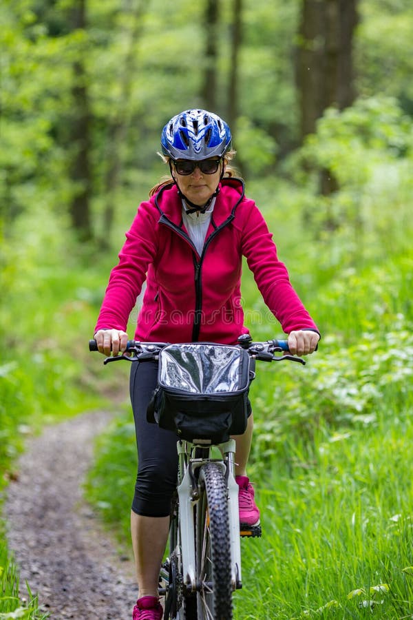 Woman riding bike stock image. Image of action, active - 101336487