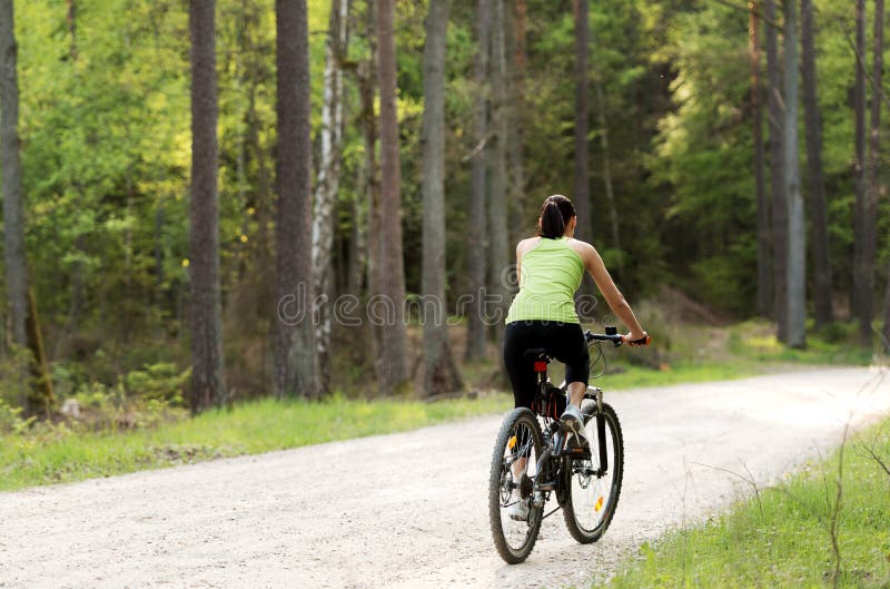 Woman riding bike outside stock photo. Image of ride - 191684202