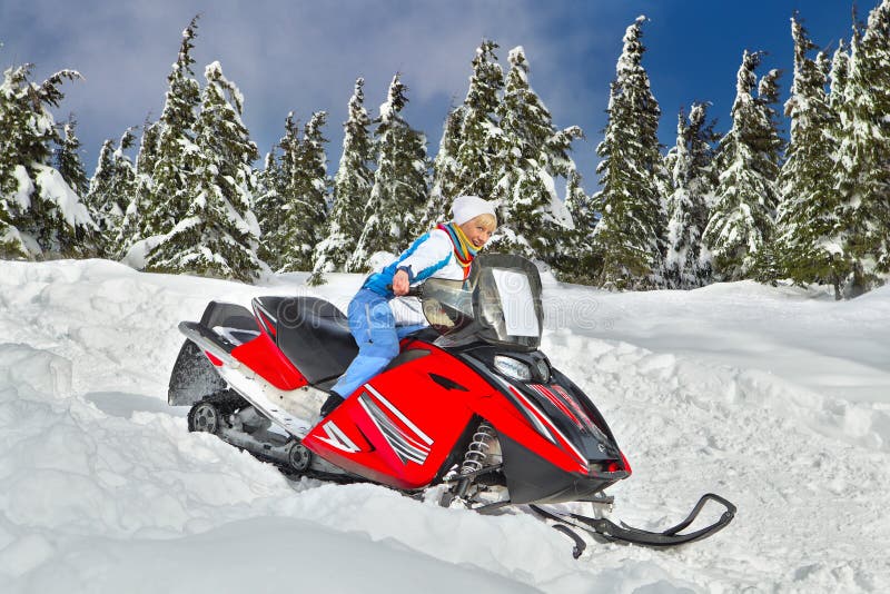 Woman riding a snowmobile stock photo. Image of driver - 28041614