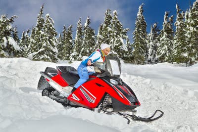 Woman riding a snowmobile stock photo. Image of driver - 28041614