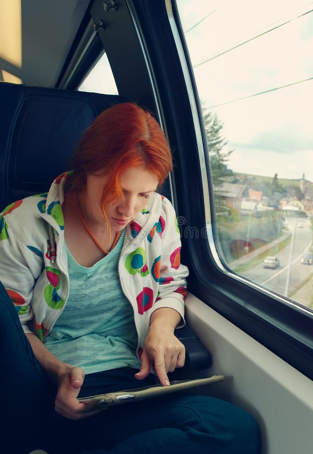 Woman riding on a train stock photo. Image of tablet - 107803370