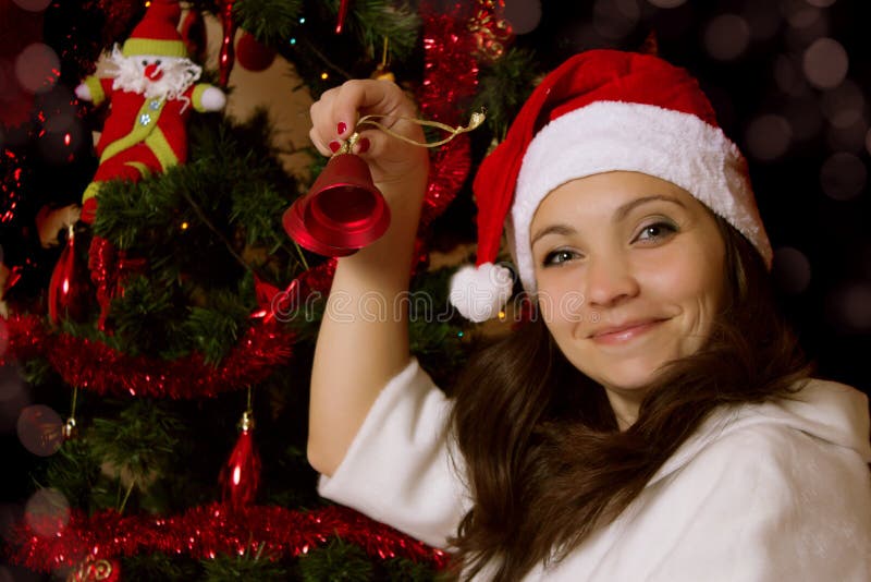 Woman Ringing the Bell Under Christmas Tree Stock Photo - Image of ...