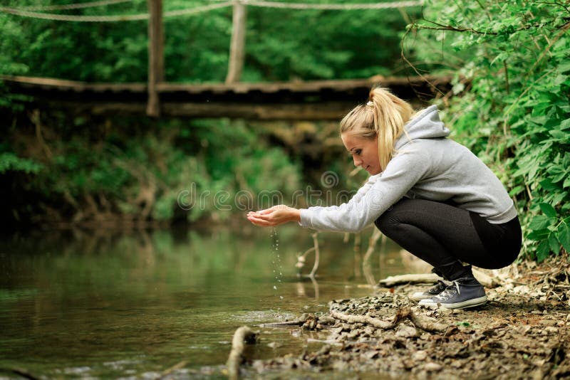 Woman Drinking a Fresh Water Stream Stock Photo - Image of handful ...