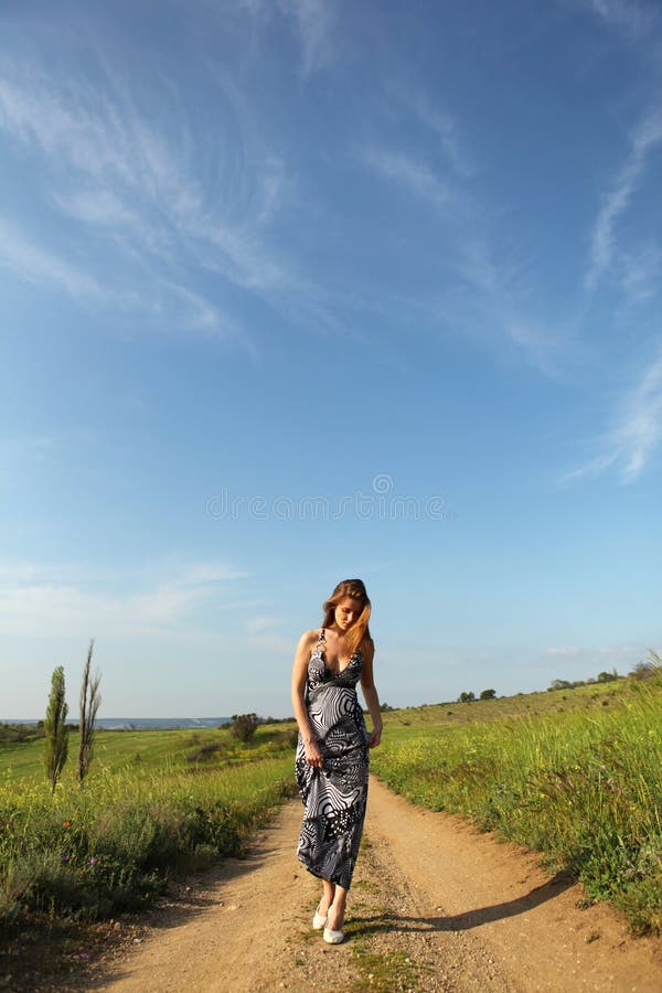 Woman on the road stock image. Image of meadow, road - 15641621