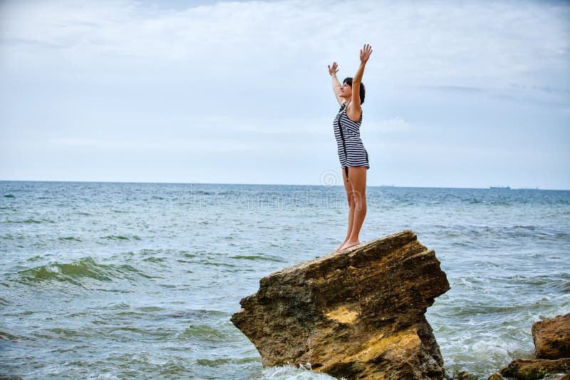 Woman on rock in beach stock photo. Image of lifestyle - 42609534