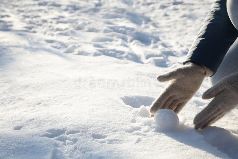 Woman Rolling Snowball Outdoors on Winter Day, Closeup. Space for Text ...