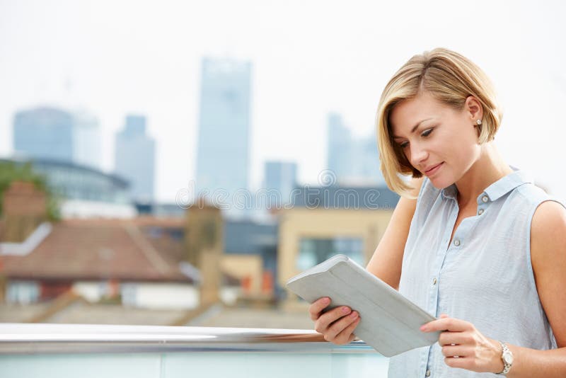 Woman on Roof Terrace Using Digital Tablet Stock Photo - Image of woman ...