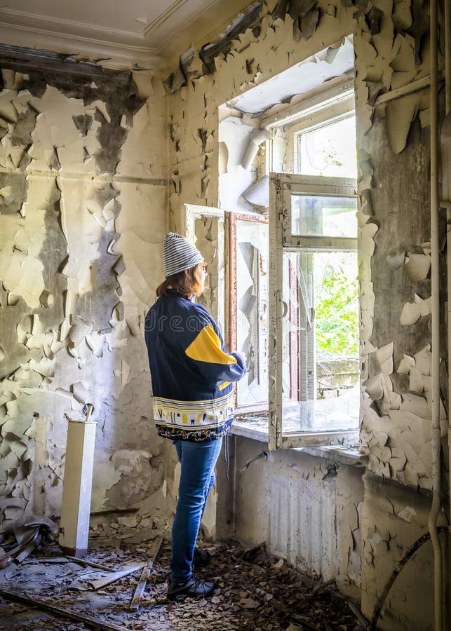 Woman in a Room with Peeling Walls and Broken Window in Abandoned ... Woman in a Room with Peeling Walls and Broken Window in Abandoned ...