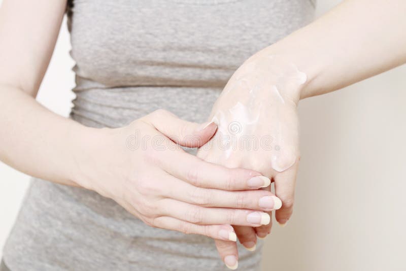 Woman Rubbing Cream in Hands Stock Photo - Image of young, treatment ...