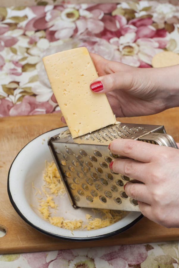 Woman rubs cheese stock image. Image of cheddar, equipment - 62887433