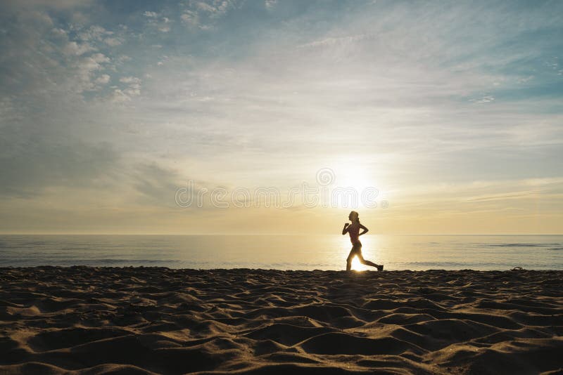 Woman Running on the Beach. Stock Photo - Image of sunset, running ...
