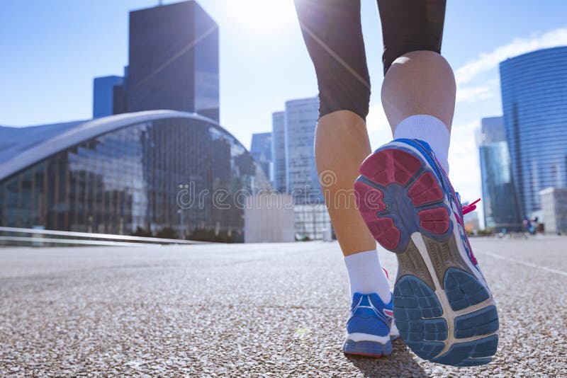 Woman running in the city stock photo. Image of exercise - 219885776