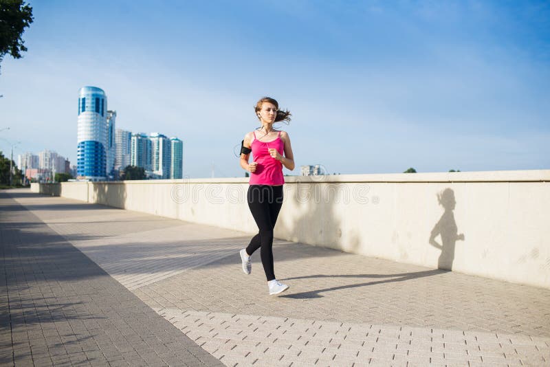 Woman running in the city stock photo. Image of people - 77037730
