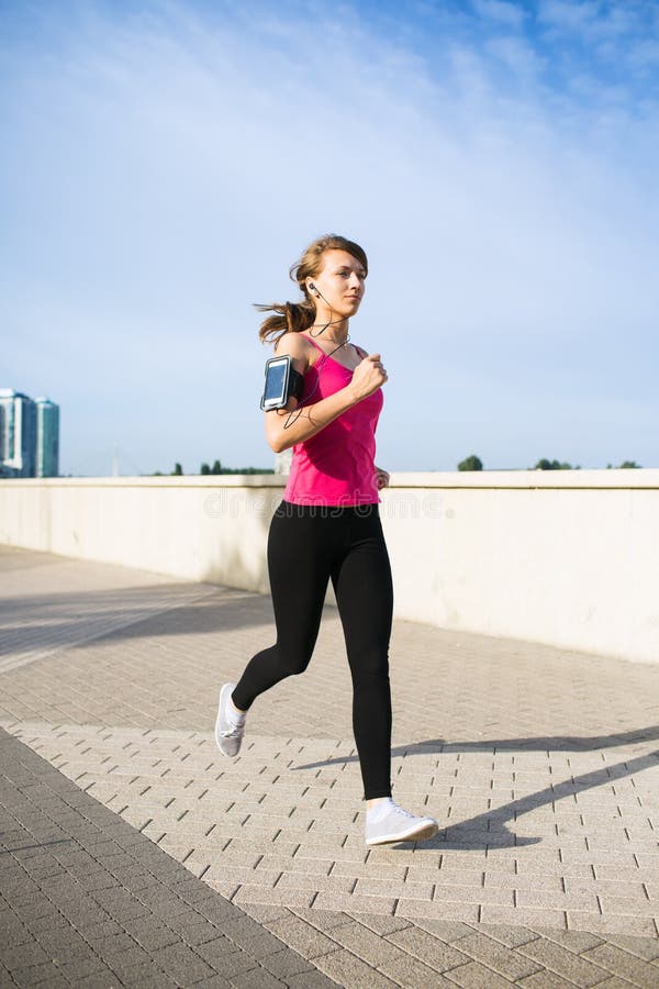 Woman running in the city stock image. Image of sport - 77037761