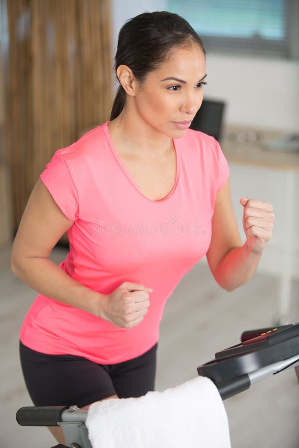 Woman Running on Exercise Machine Stock Image - Image of training ...