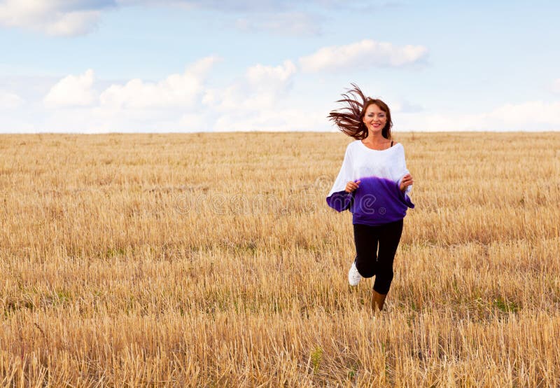A Woman is Running through the Field Stock Photo - Image of nature ...