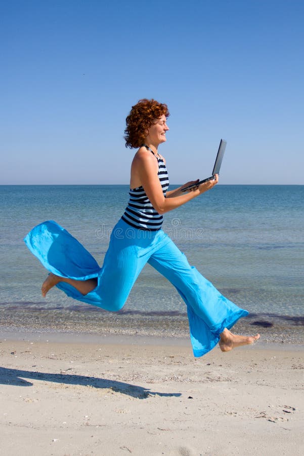 Woman Running With Laptop Computer Picture. Image: 7881313