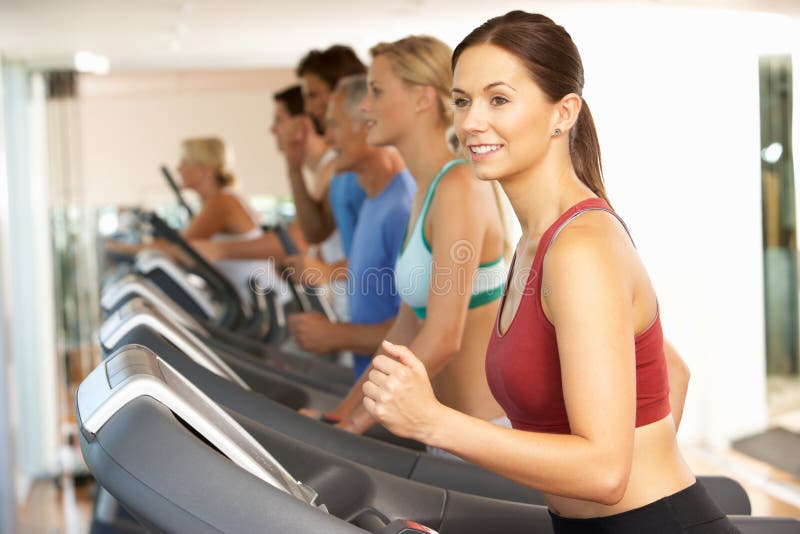 Woman on Running Machine stock photo. Image of young - 16301836