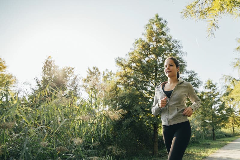 Woman running in park stock photo. Image of nature, athlete - 64783530