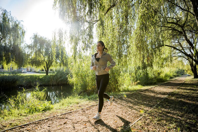 Woman running in park stock image. Image of girl, park - 99060601