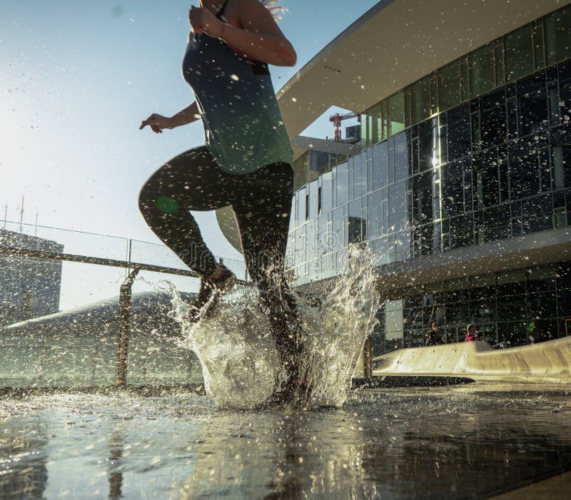 Woman Running in the Puddle with the Water Splashing Stock Image ...