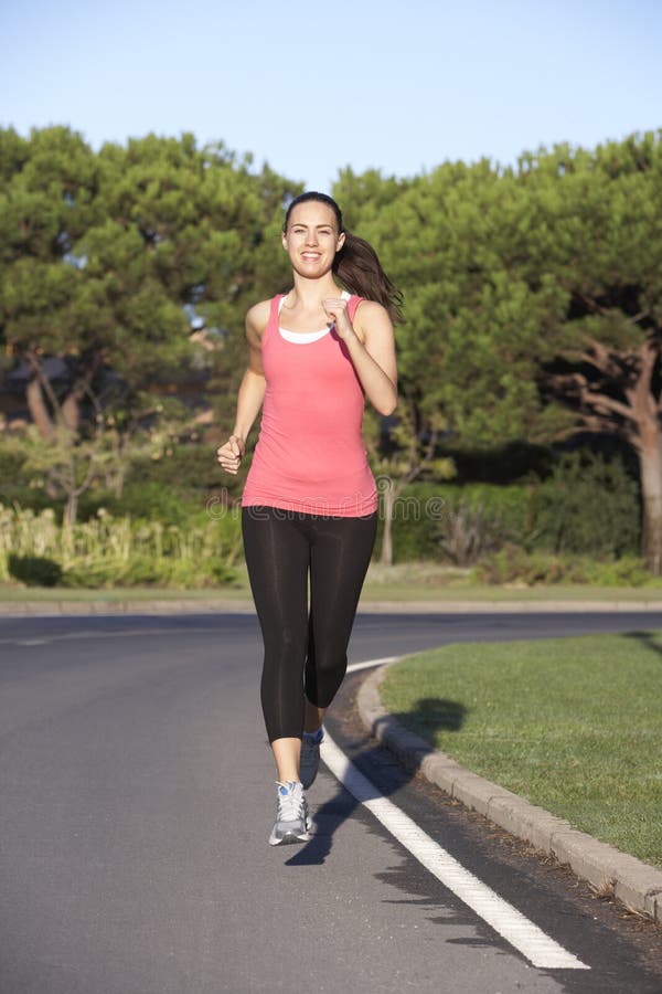 Woman Running on Road stock image. Image of road, runner - 55890687