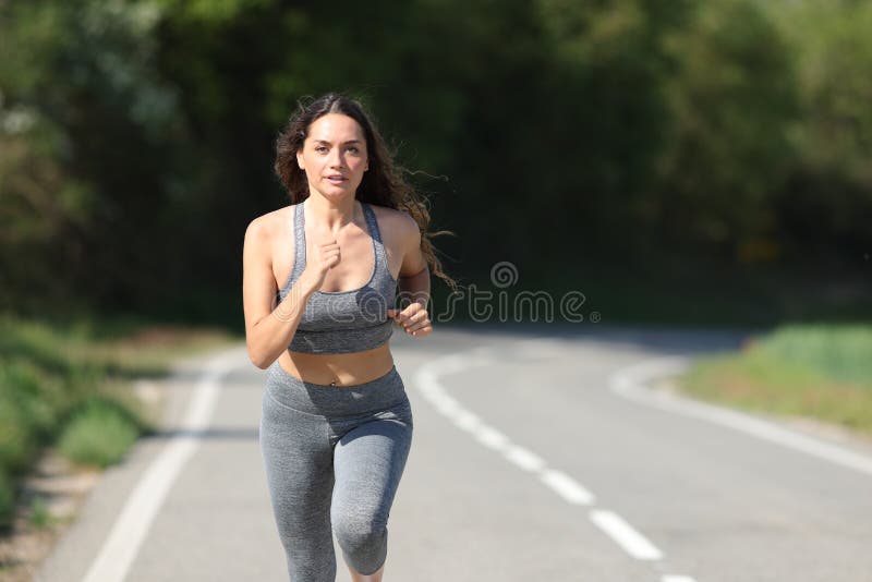 Woman running in a road stock image. Image of endurance - 267281553