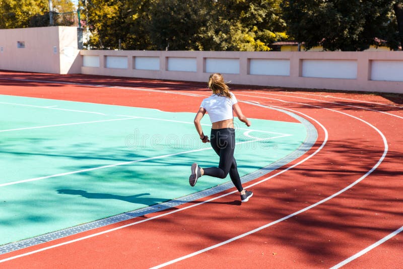 Woman running at stadium stock image. Image of person - 61011395