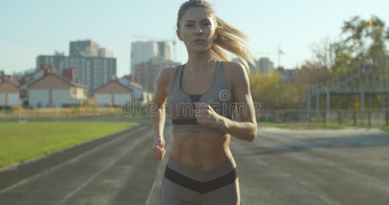 Woman Running at a Stadium in Sunny Day. Stock Photo - Image of jogger ...