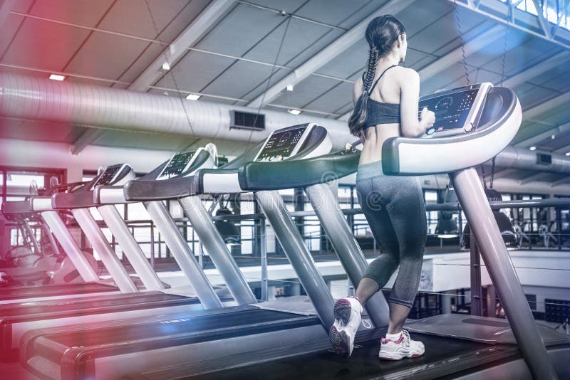 Woman running on treadmill stock photo. Image of athlete - 84431256