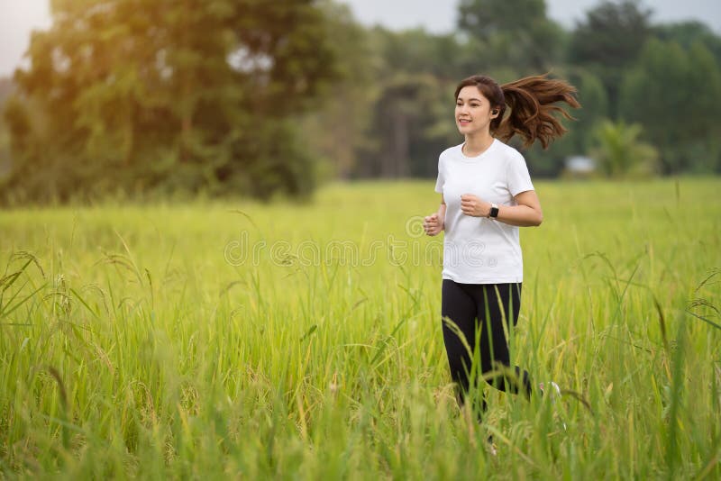 Woman Running on Wooden Path in Field Stock Photo - Image of field ...