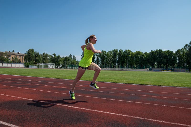 Woman runs in the stadium stock photo. Image of asian - 255054836