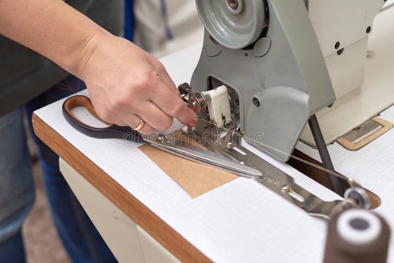 A Woman Runs a Thread in the Sewing Machine Stock Image - Image of ...