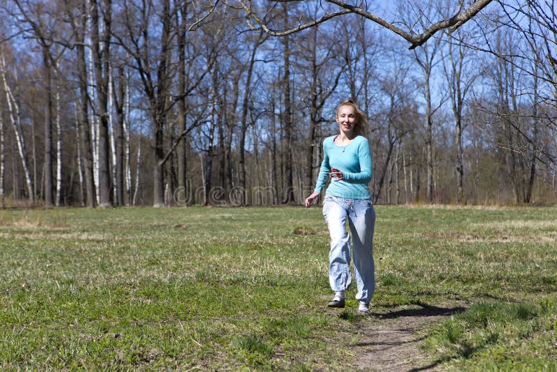 The Woman Runs on the Track in the Spring Wood Stock Photo - Image of ...