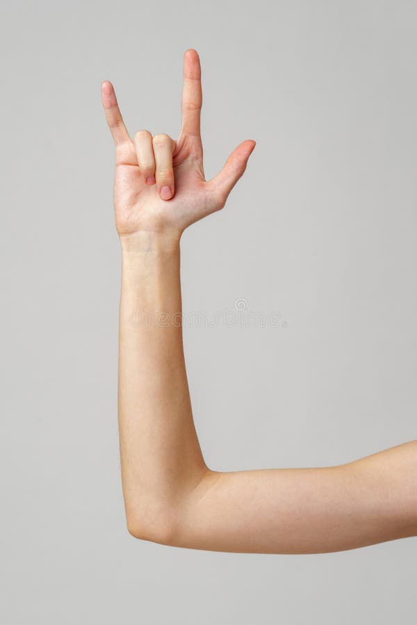 A Woman& X27;s Arm Making a Rock on Hand Gesture Stock Photo - Image of ...