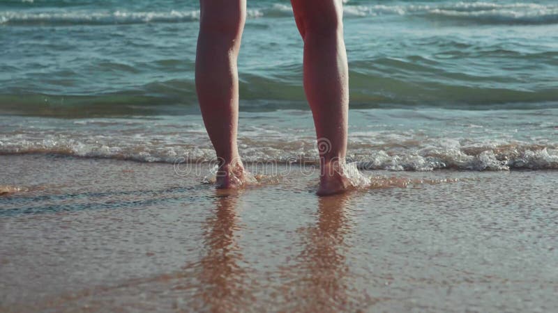 Woman S Feet Hit by a Small Wave on the Seashore Stock Footage - Video ...