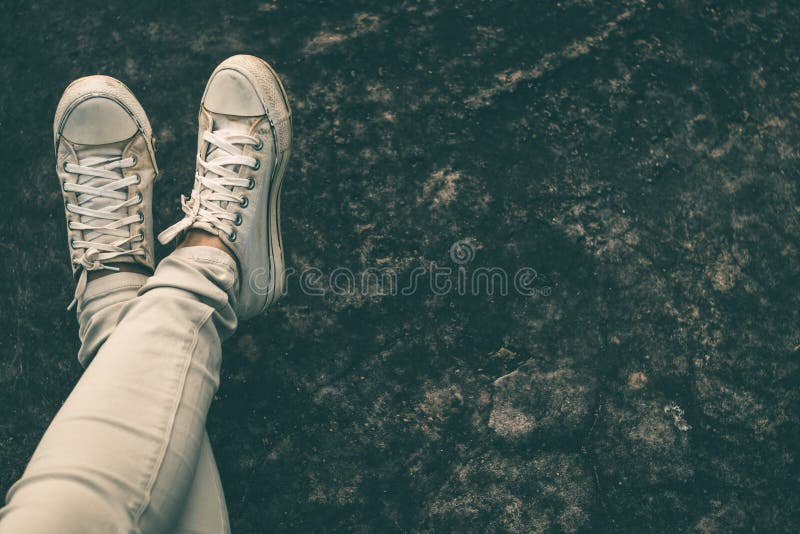Woman`s feet sit relaxed. stock photo. Image of people - 136564896