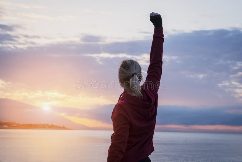 A Woman`s Freedom with His Hand Raised at the Seaside. Stock Photo ...