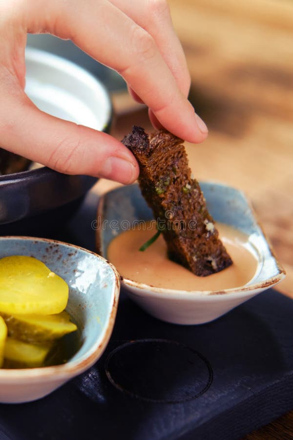 A Hand Dips a Piece of Challah in Honey in Honor of the Celebration of ...