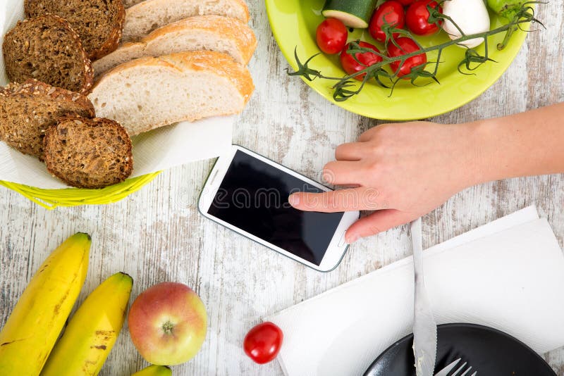 A Woman`s Hand with Food and Phone Stock Image - Image of brown, hands ...