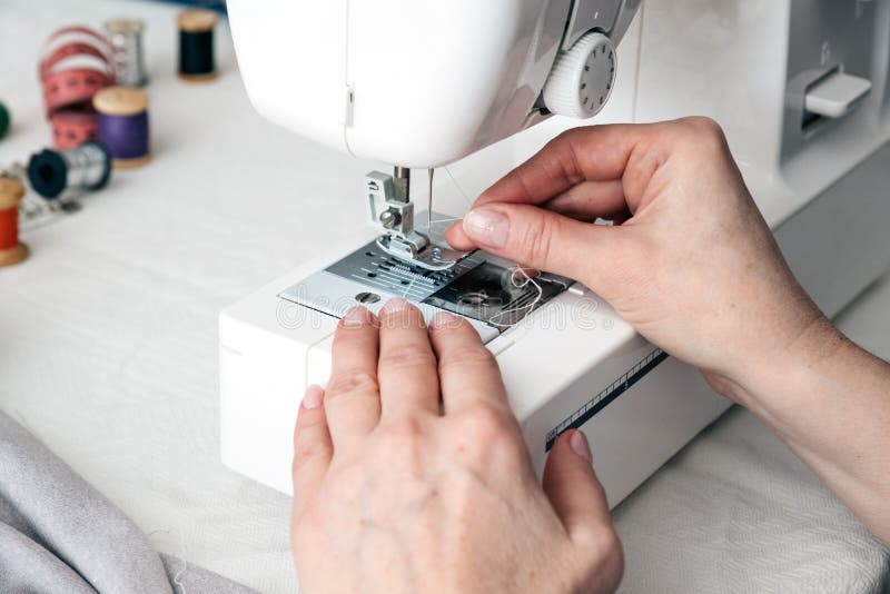 Holding Thread and Threading a Sewing Machine Needle, Close Up View ...