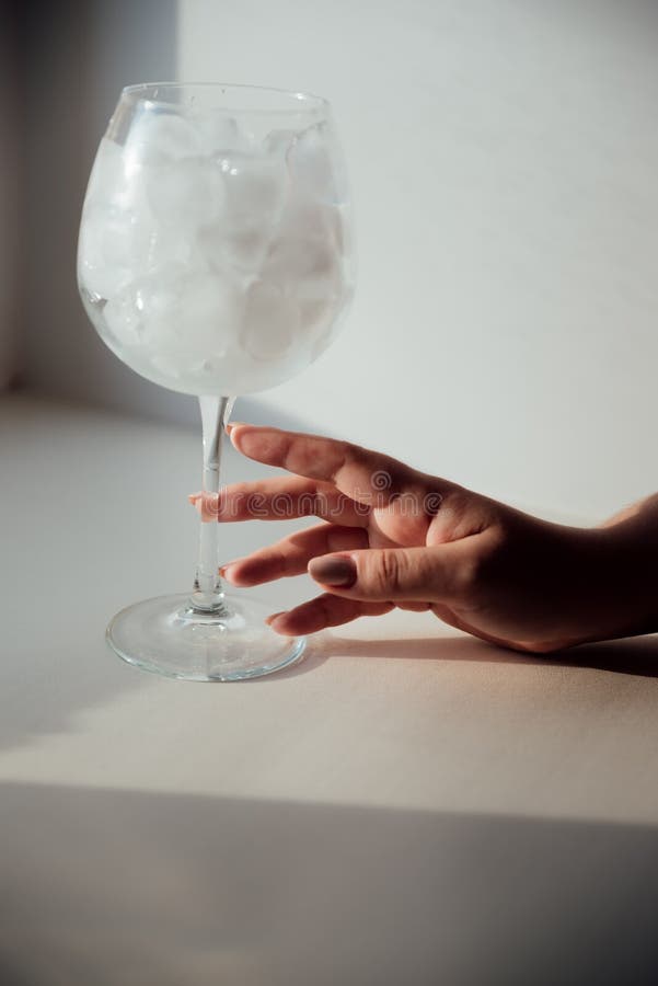 A Woman S Hand Holds a Glass with Ice Stock Photo - Image of table ...