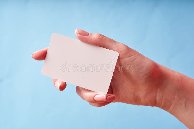 A Woman`s Hand Holds a White Plastic Card. Isolated Card in Hand Stock ...