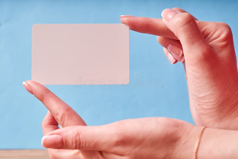 A Woman`s Hand Holds a White Plastic Card. Isolated Card in Hand Stock ...