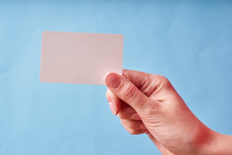 A Woman`s Hand Holds a White Plastic Card. Isolated Card in Hand Stock ...